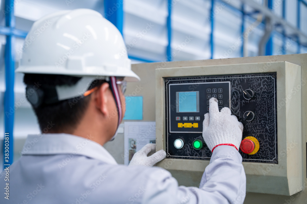 Asian technician worker wearing a safety suit and setting Shearing ...