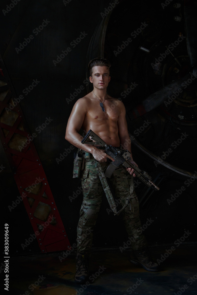 A strong attractive soldier with a muscular torso in an American ...