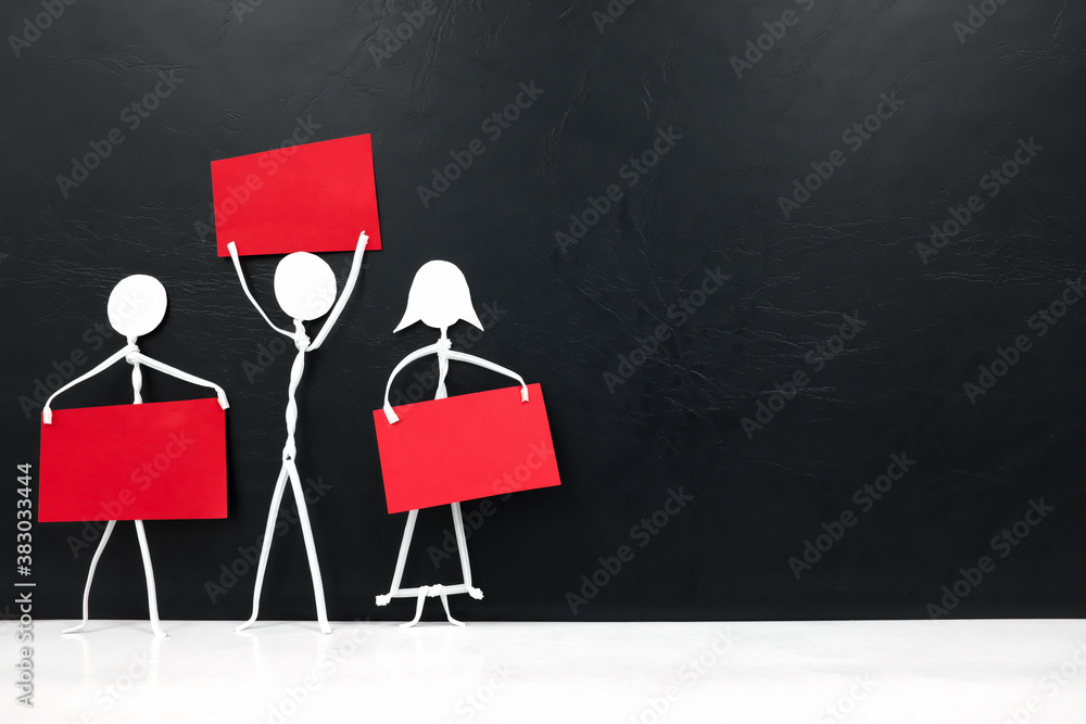 Three men and women stick figure holding red blank placards in black ...