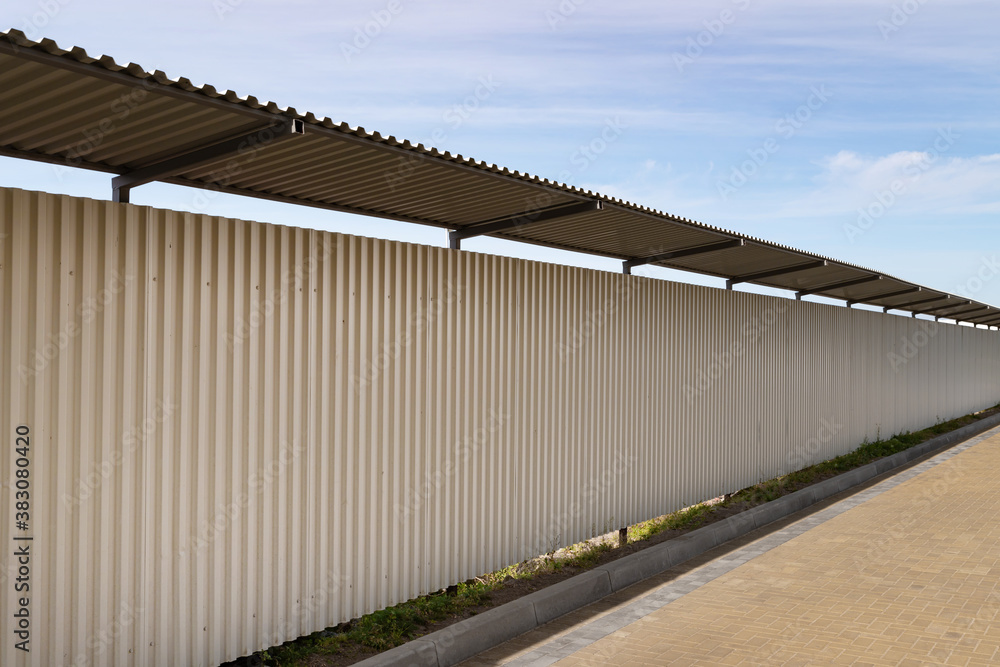 Metal profile sheet fence. Perimeter fencing of facilities under ...