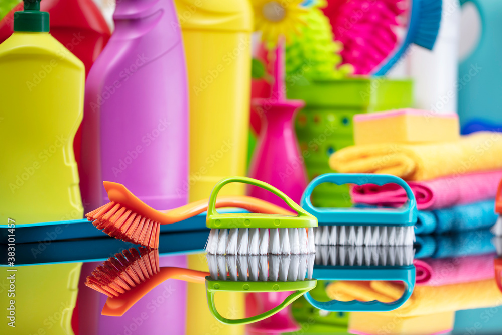 House and office cleaning theme. Colorful cleaning kit on shing glass ...