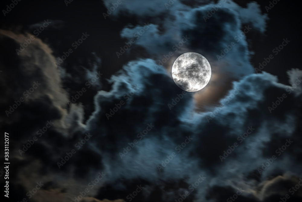 Full moon in between the clouds and idyllic scenery for a Halloween ...