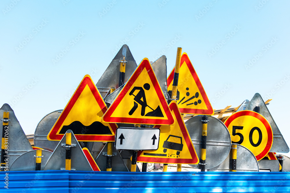 Road repair concept, group of yellow and red roadsigns for work in ...