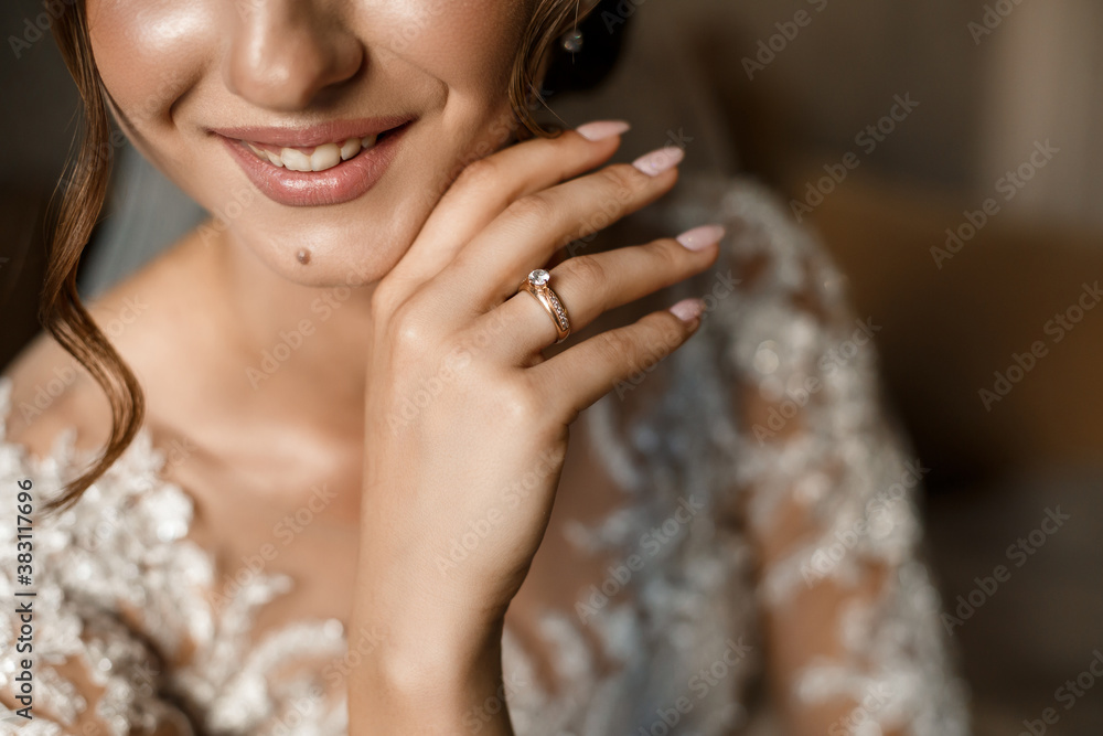 Gentle female hands of the bride with a gold wedding ring on the ring ...