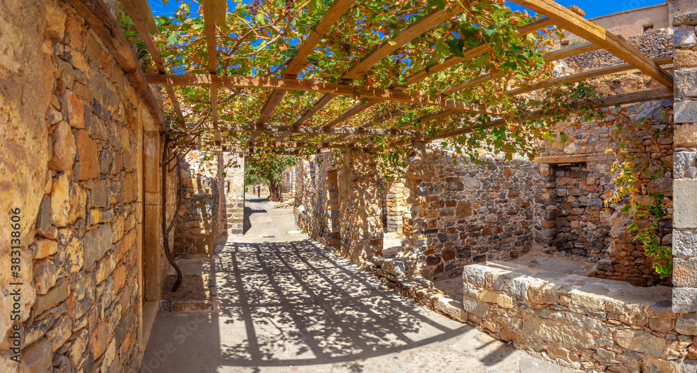 View of the island of Spinalonga with calm sea. Here were isolated ...