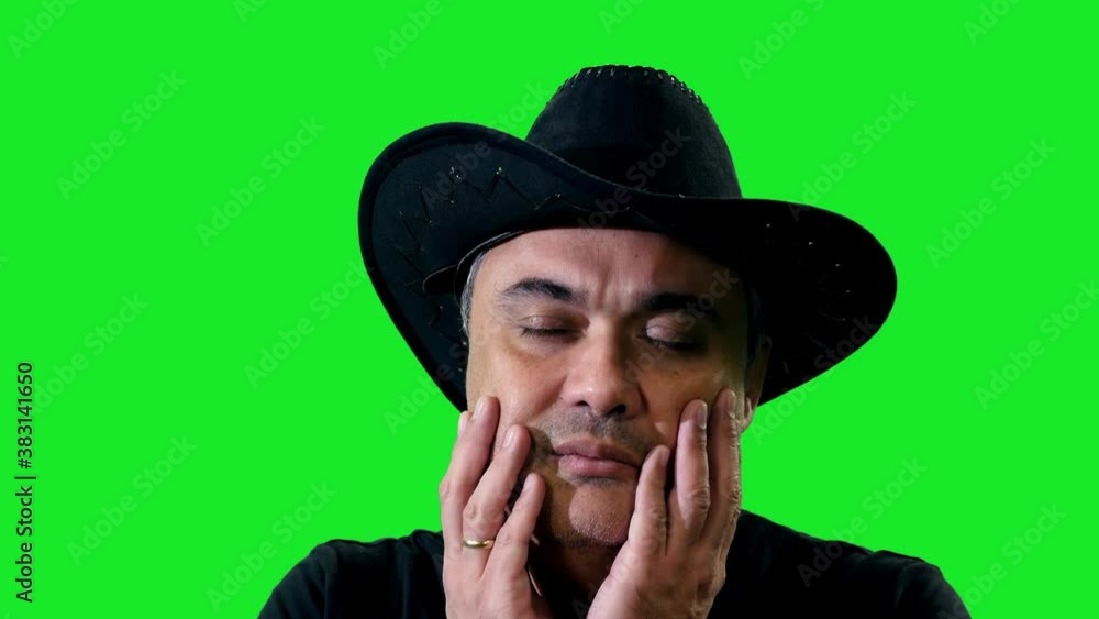 Portrait of adult man in black t-shirt and cowboy hat suffering from ...