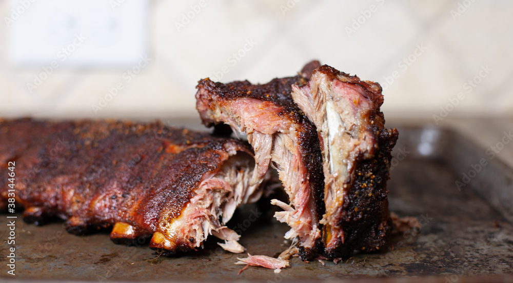 Tender Baby Back Ribs with a nice bark, sliced before being served ...