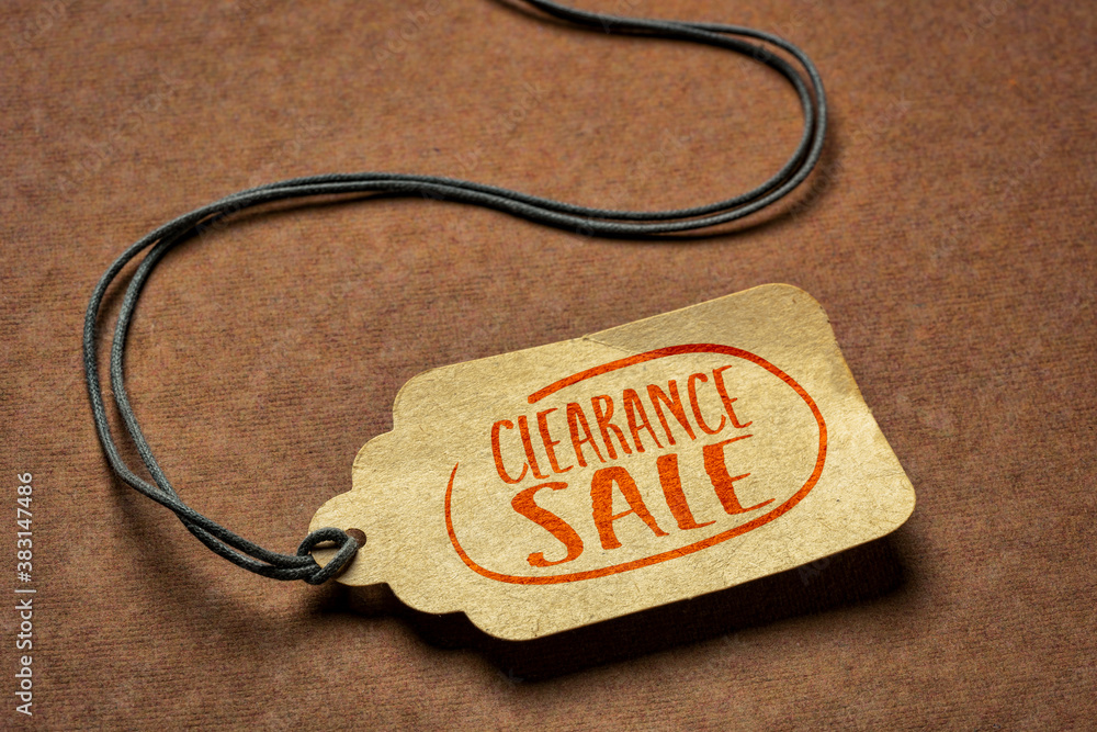 clearance sale sign a paper price tag against textured brown paper ...