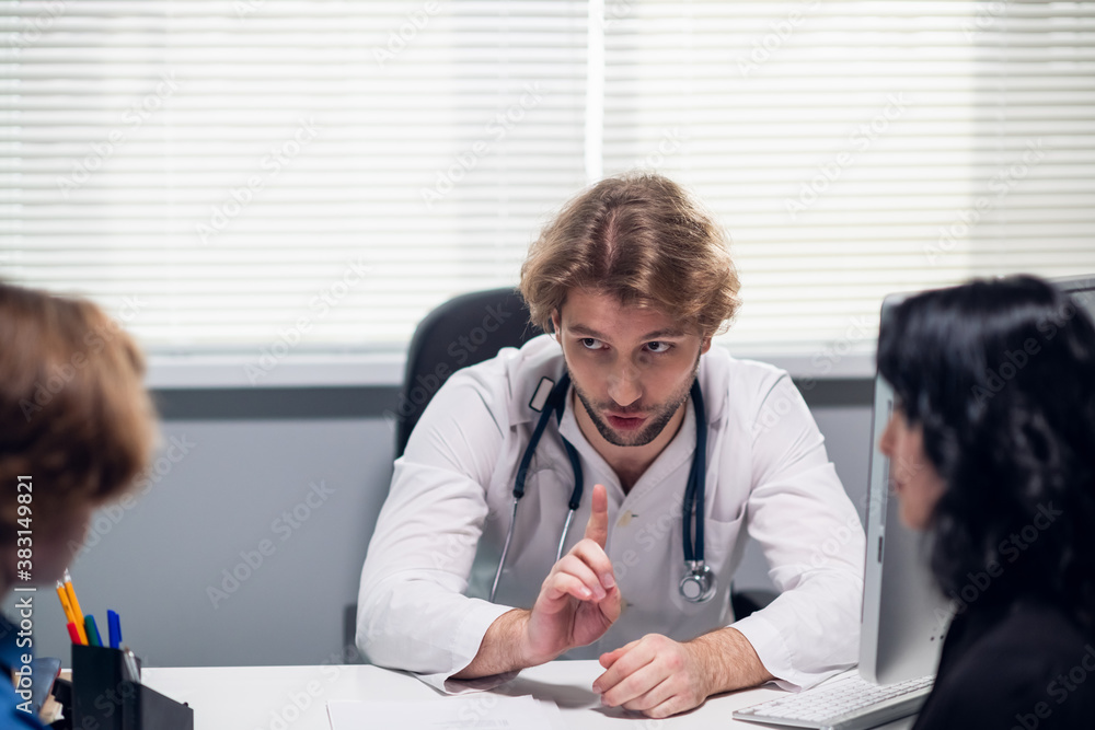 A family doctor conducting a medical checkup, asking questions, making ...