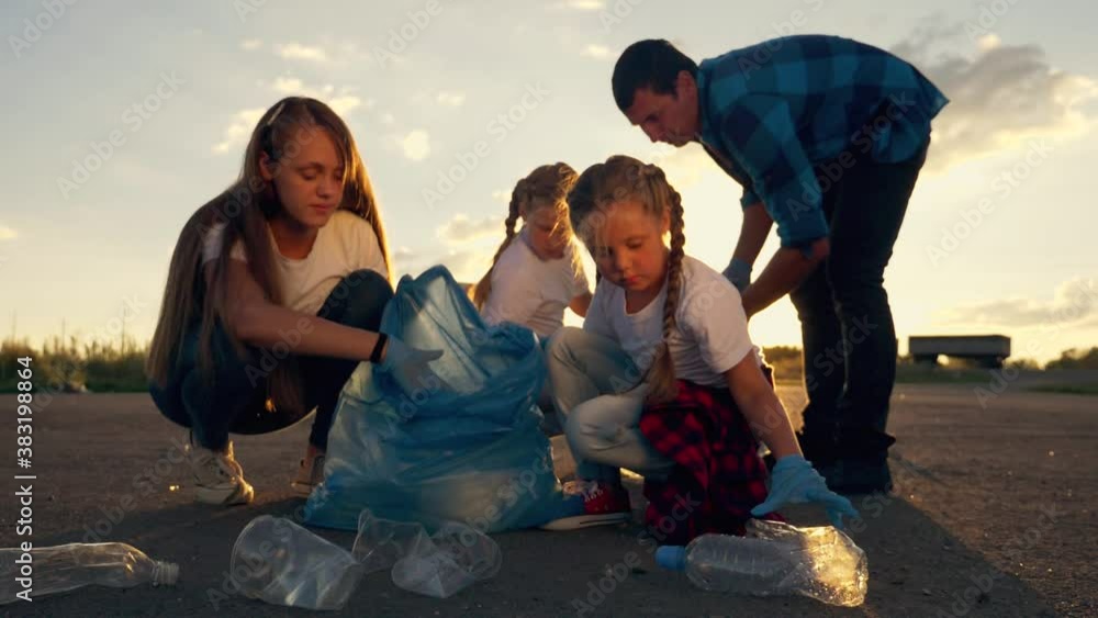 Volunteers father and daughters take away plastic waste. Happy family ...