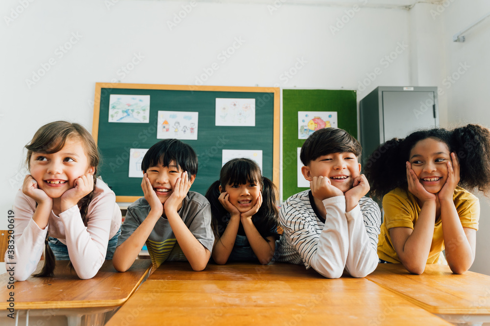 Cheerful multiethnic school friends facing camera with hands on chin ...