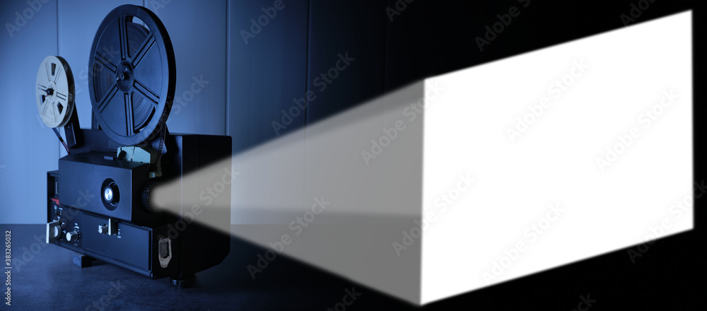 Elegant view of old 8mm cinema movie projector with white screen for ...