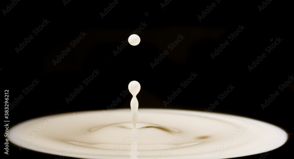 Drop of milk - milk droplet falling on white liquid and creating splash ...