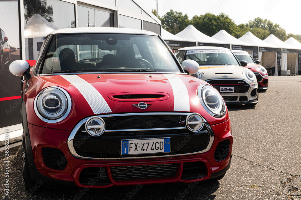 Mini cooper car front view red hood and cars aligned in background ...