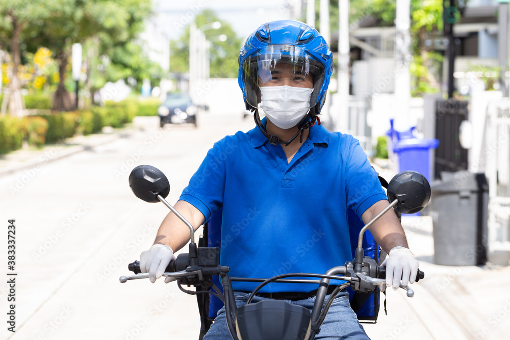 Delivery man wearing blue uniform riding motorcycle and delivery box ...