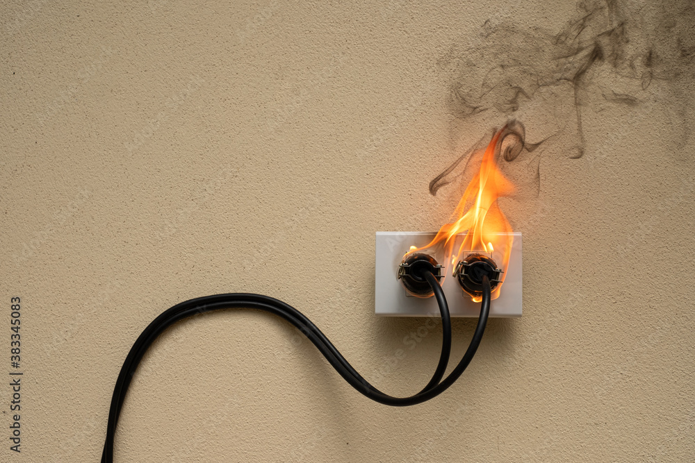 On fire electric wire plug Receptacle on the concrete wall background ...