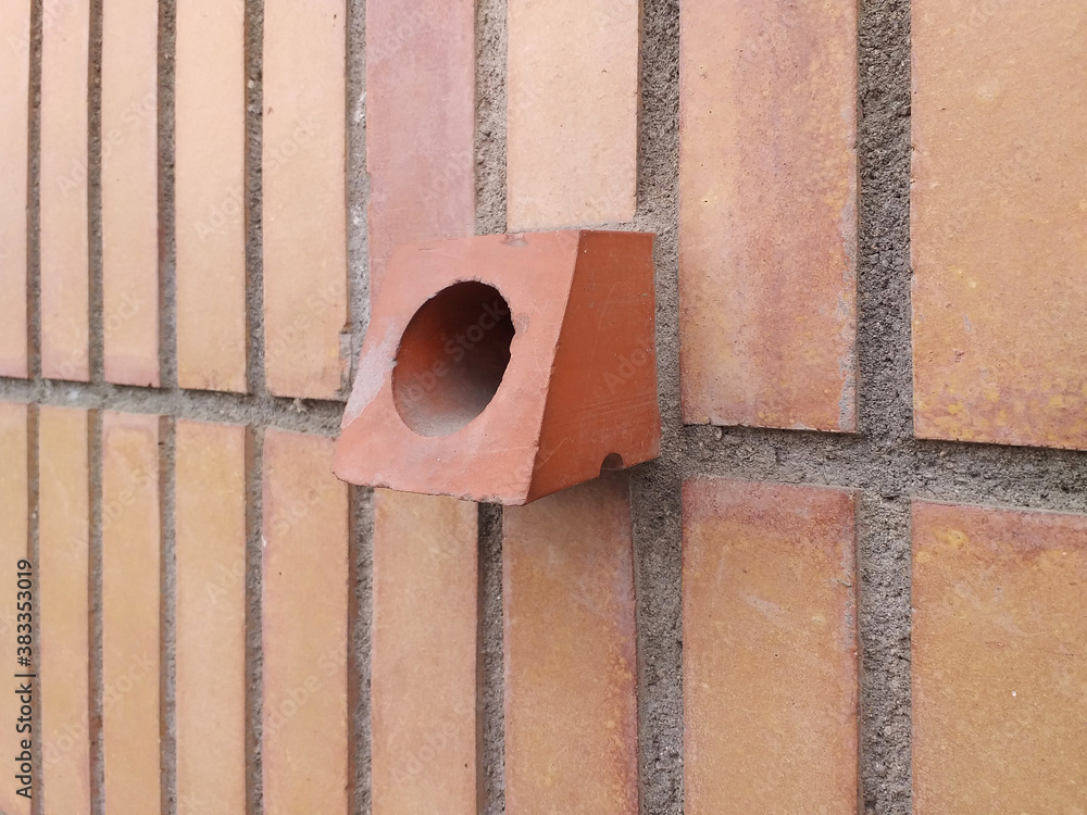 Round rain gutter in brick wall to evacuate water and humidity. Auction ...