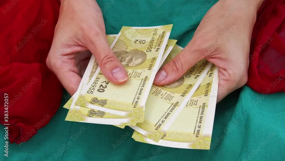 Close up view of female hands with new indian 20 rupees banknote. Stock ...
