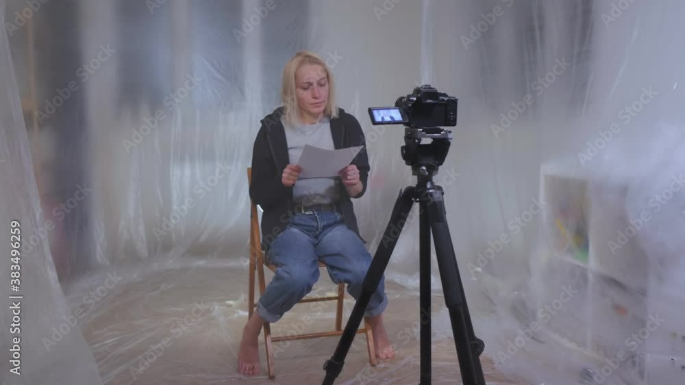 A female hostage sitting on a chair reads a text from a paper to the ...