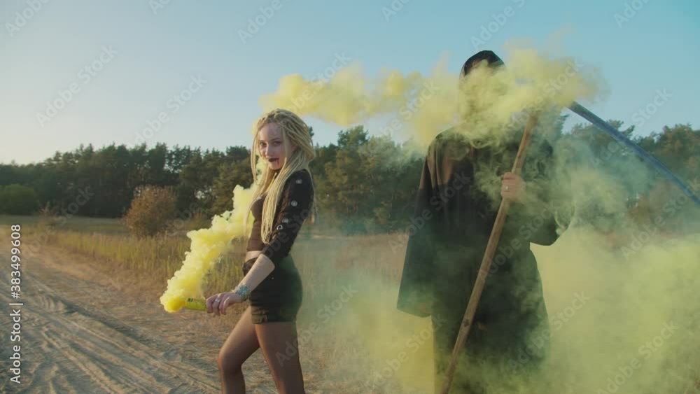 Scary female vampire with dreadlocks holding yellow smoke bomb and ...