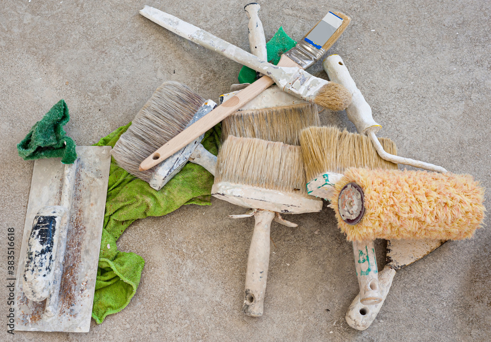 Paints and construction brushes, used paint brushes in a jar with ...