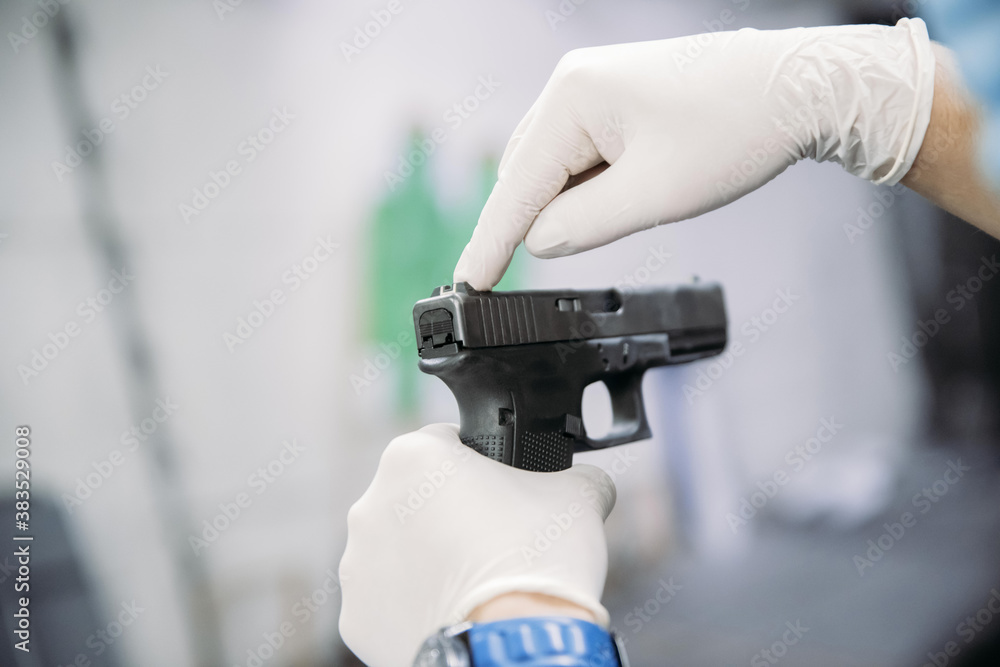 Living in a pandemic. Shooting instructor in gloves showing to the ...