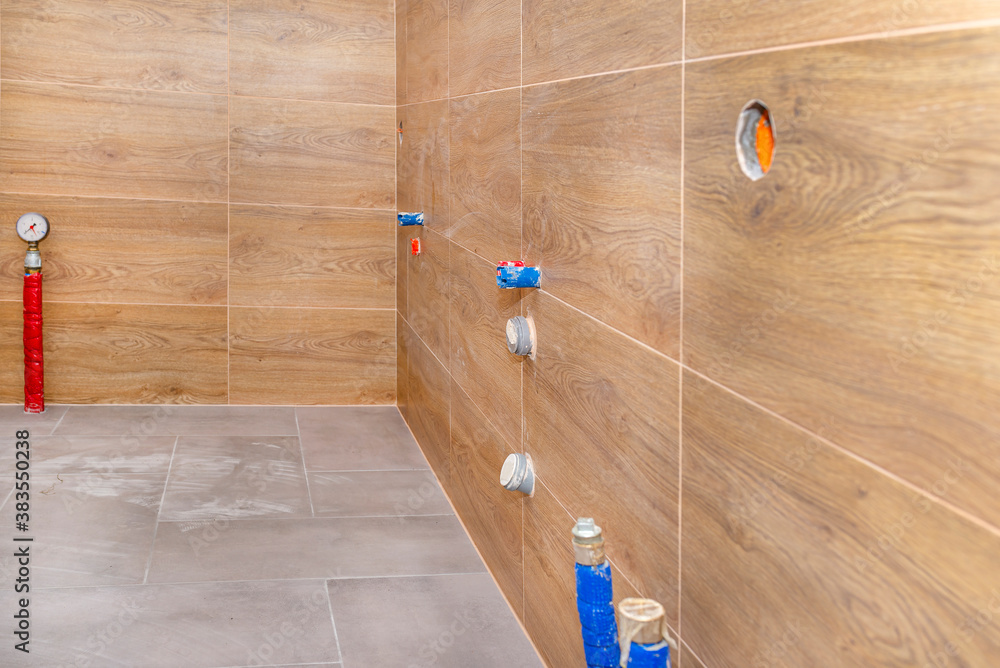 Water pipes, underfloor heating pipes coming out of the floor and and ...