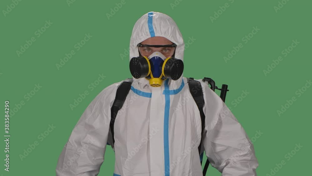 Portrait male in a protective suit, safety glasses, gloves and a ...