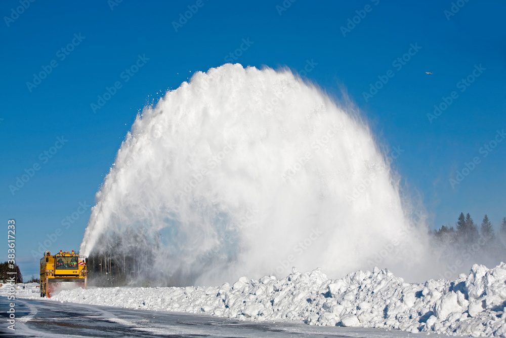 Snow blower throwing snow at airport runway Stock Photo | Adobe Stock