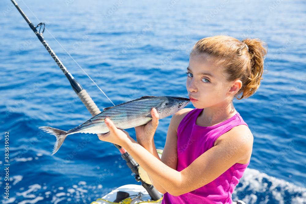 kid girl fishing tuna bonito sarda kissing fish for release Stock Photo ...