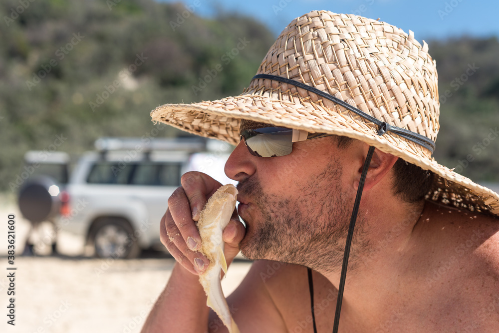 silly man kissing a fish before throwing it back Stock Photo | Adobe Stock