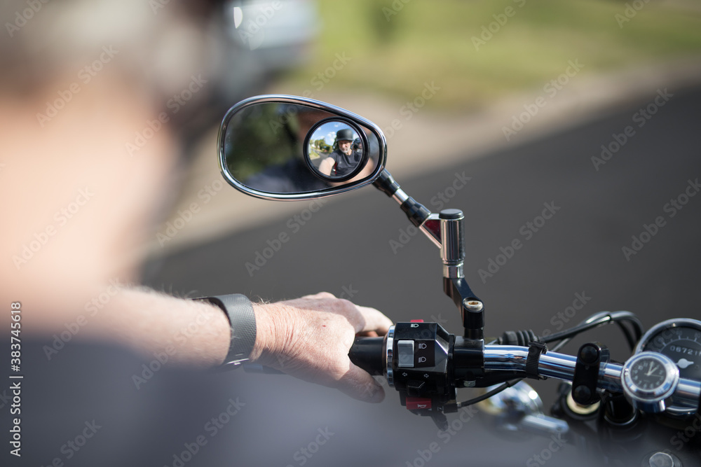 View of a male active senior man riding his bike looking down at the ...