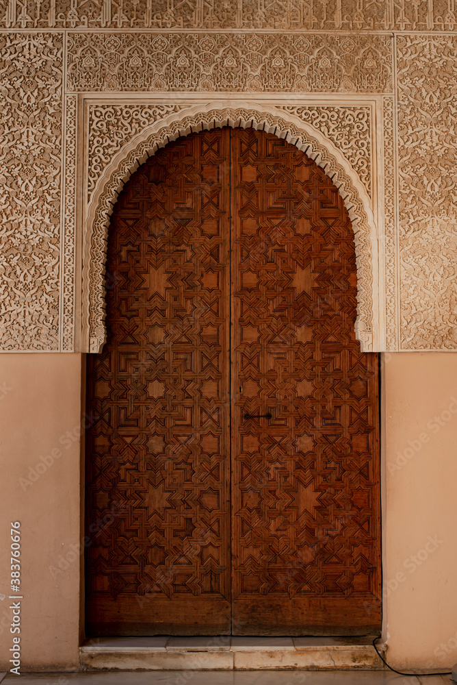 Beautiful architecture with an arch wooden door in the Moorish style at ...