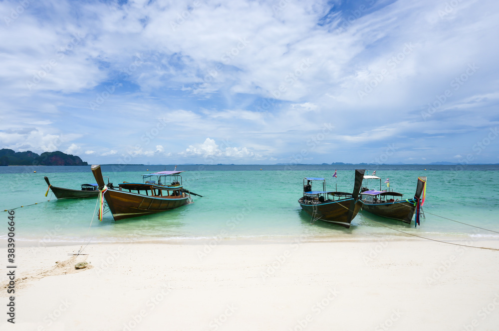 Beautiful views of the sandy beach with long-tailed wooden boats docked ...
