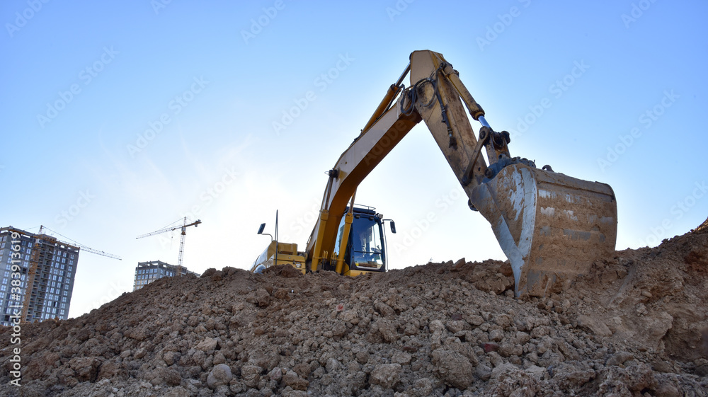 Excavator working at largest construction site. Backhoe on earthworks ...