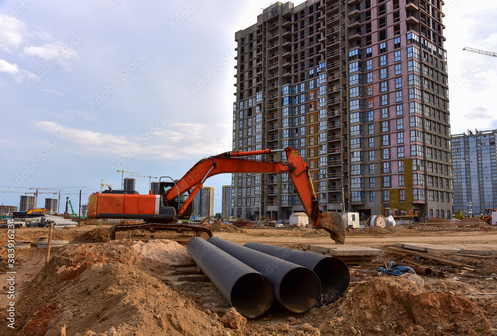 Excavator dig the trenches at a construction site. Trench for laying ...