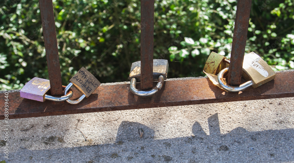 Keyless padlocks as a symbol of union in a couple anchored to the rail ...
