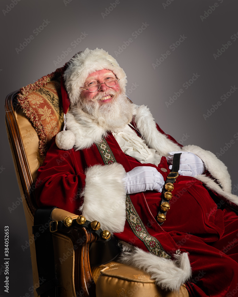 Happy tired Santa Claus relaxing on his vintage chair after Christmas ...