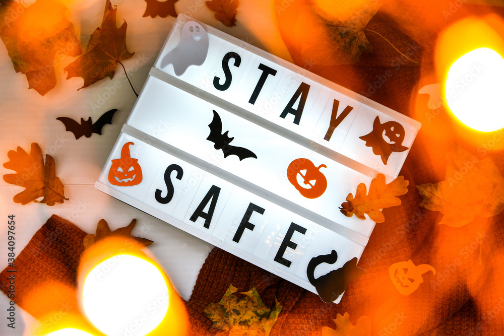 Stay safe. Text in white light box, with a background of sweater, dried ...