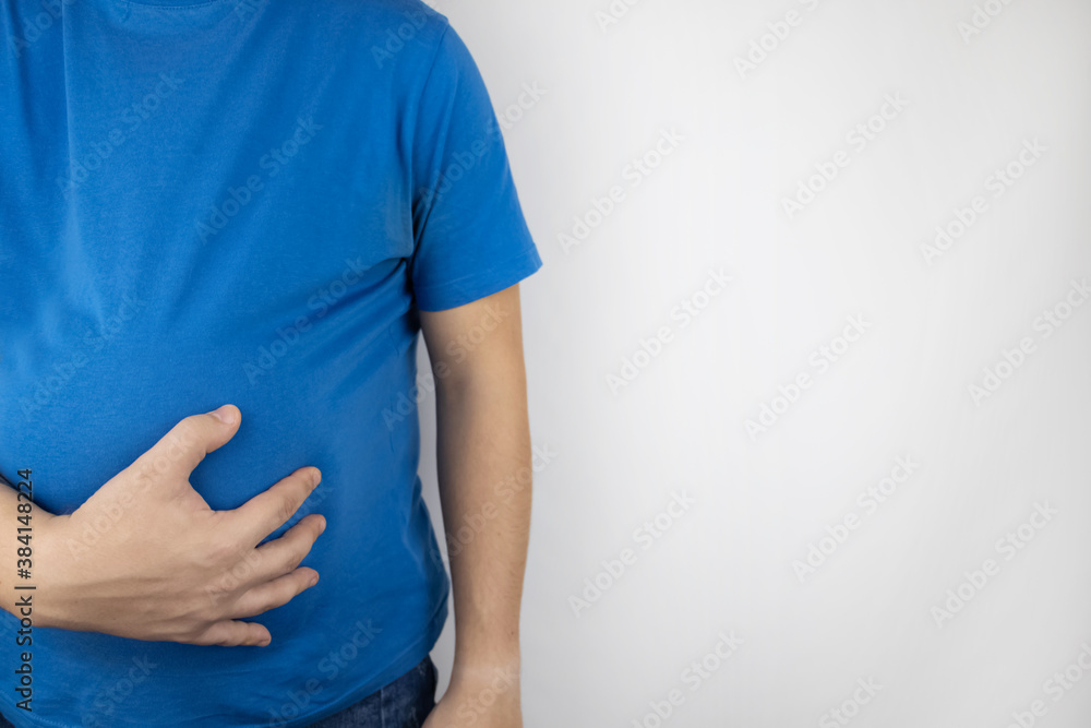 Foto de The man is holding onto his swollen belly. Bloating, flatulence ...