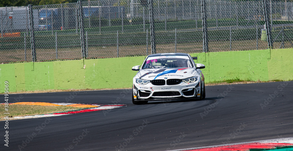 Spectacular front view of BMW M4 racing car in action during the race ...