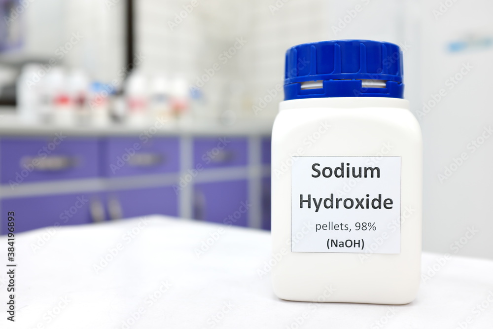 Selective focus of a bottle of pure sodium hydroxide or NaOH chemical ...