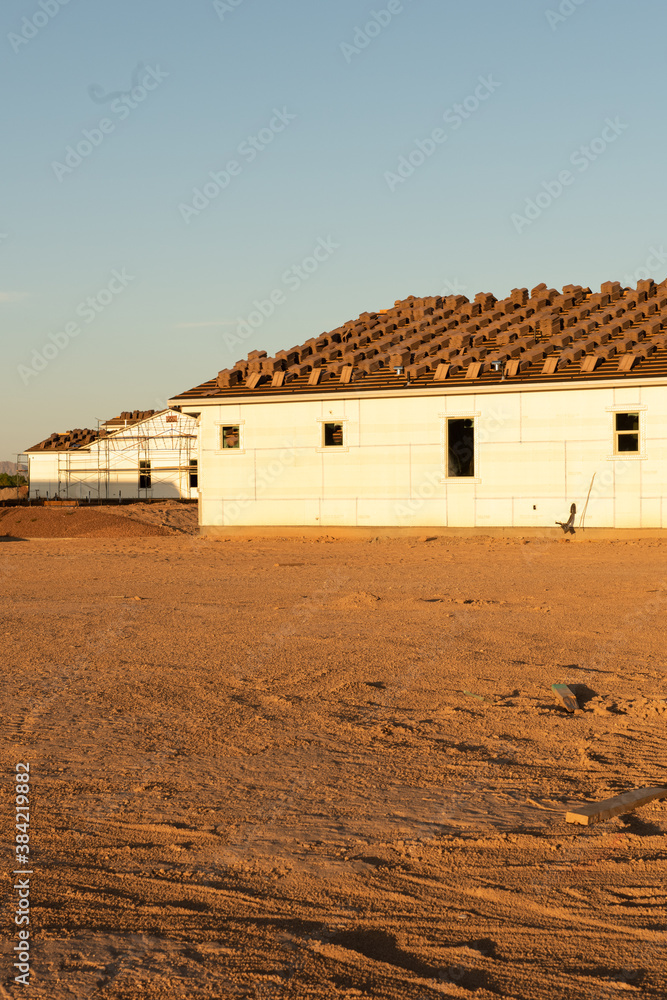 Fotografia do Stock: An unfinished house with roofing tiles stacked on ...