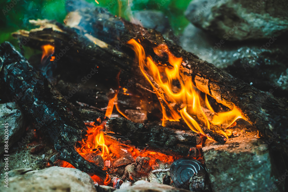 Vivid smoldered firewoods burned in fire close-up. Atmospheric warm ...