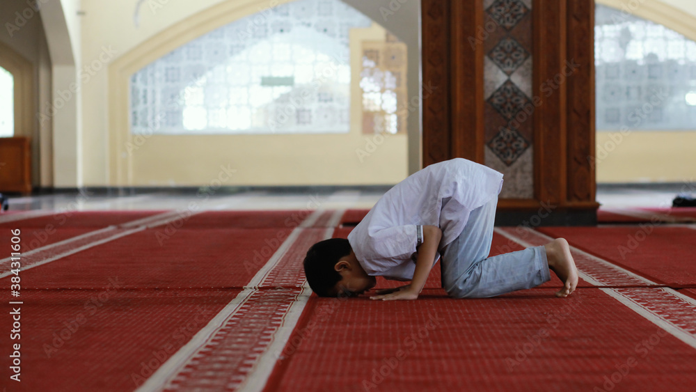 uslim boy praying in the mosque. Young Asian muslim is on his knees ...