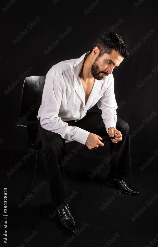 Handsome elegant man resting after a work day, sitting and pondering ...