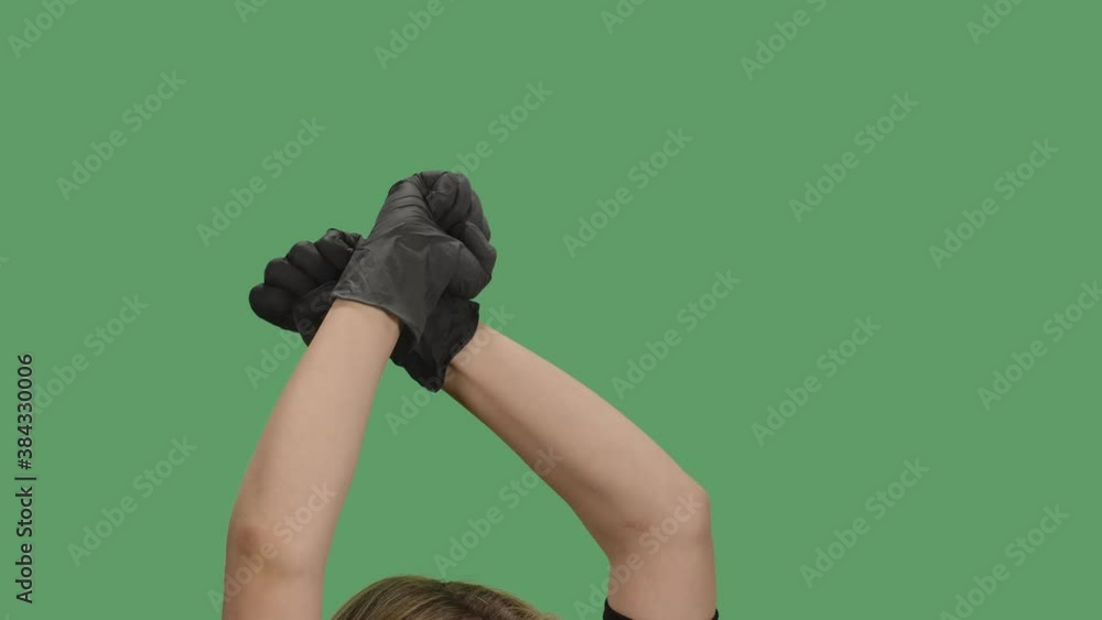 The blonde girl raises up two hands clenched into a fist. Symbol of ...