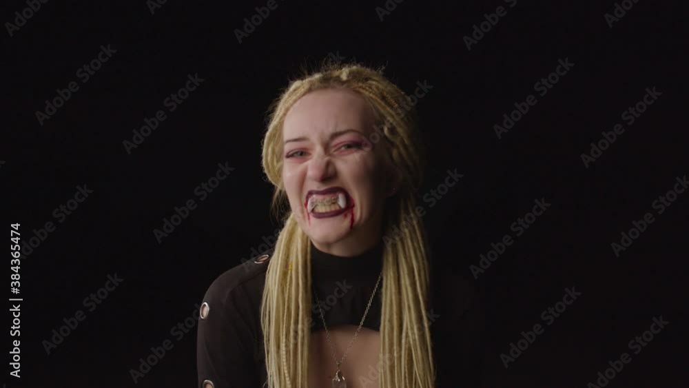 Portrait of bloodthirsty eerie attractive female vampire with ...