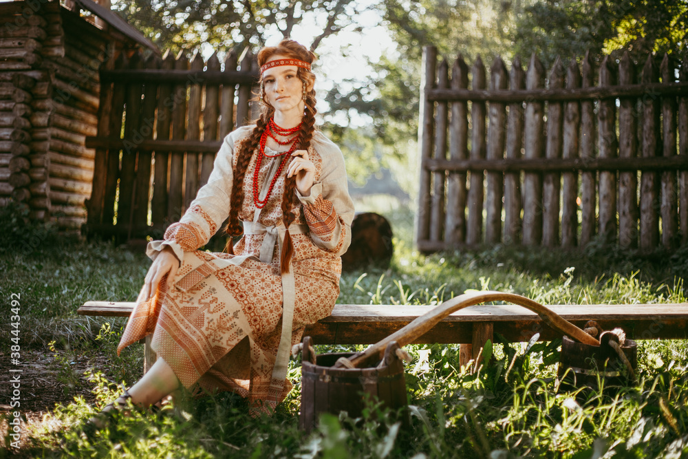 A beautiful Slavic girl with long blonde hair and brown eyes in a white ...
