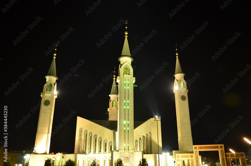 Muslim mosque in the night city. The mosque is illuminated. City mosque ...